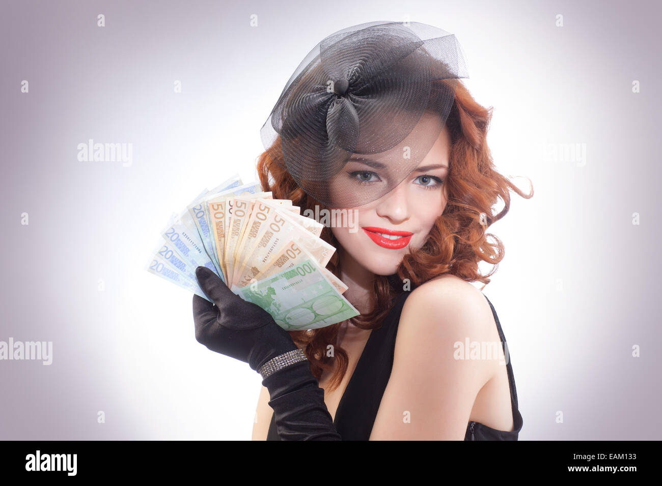 Young woman holding cash model hi-res stock photography and images - Alamy