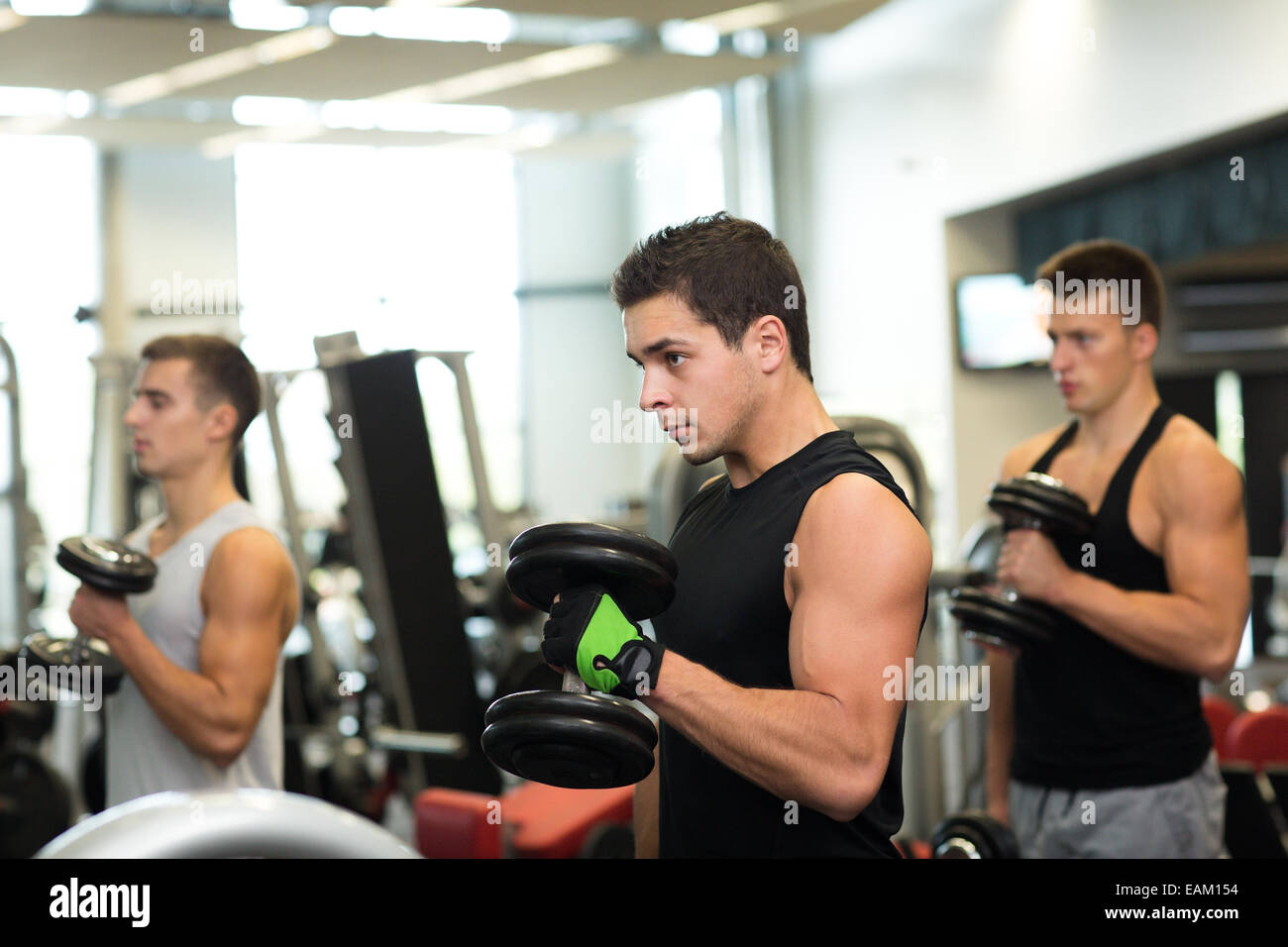 group of men with dumbbells in gym Stock Photo - Alamy