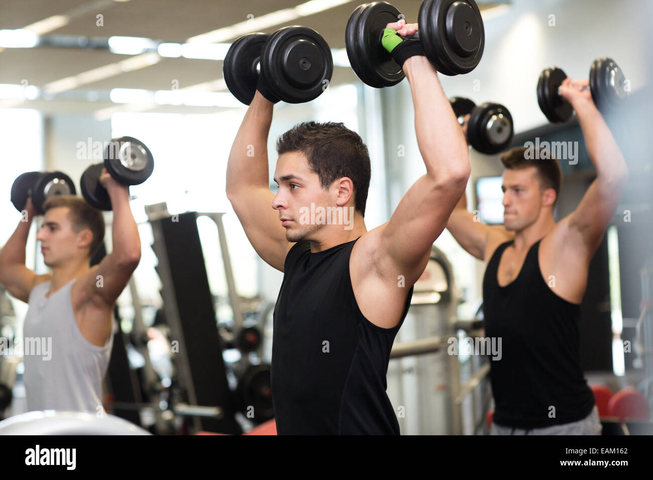 group of men with dumbbells in gym Stock Photo - Alamy