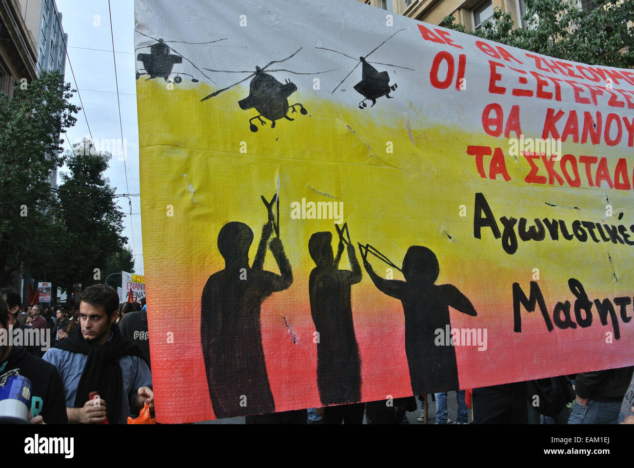 A painting with an anti war message on a banner. People in Athens ...