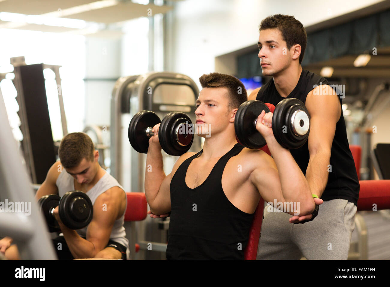 group of men with dumbbells in gym Stock Photo - Alamy
