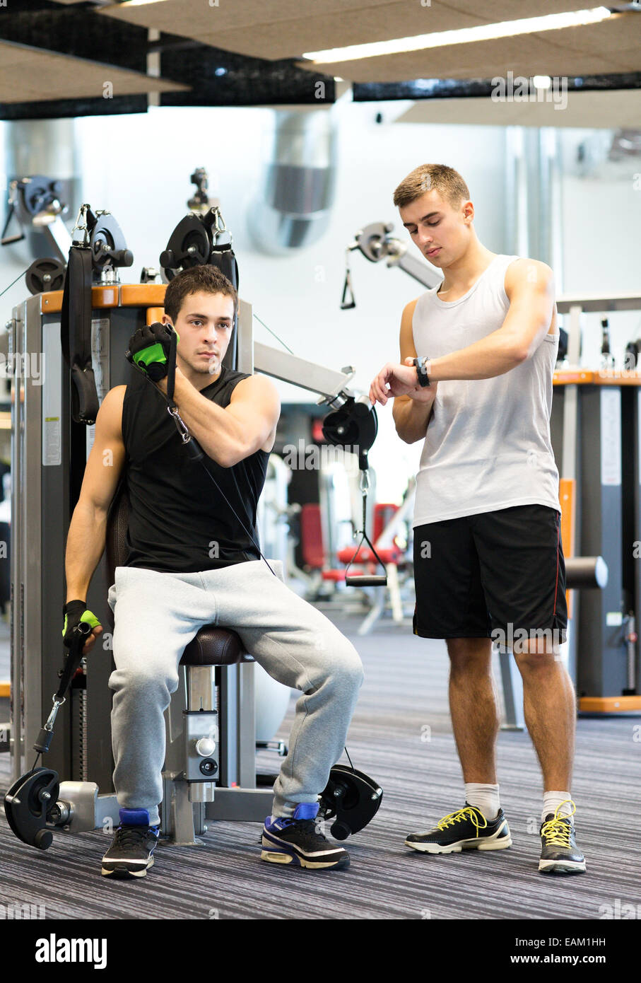 men exercising on gym machine Stock Photo - Alamy