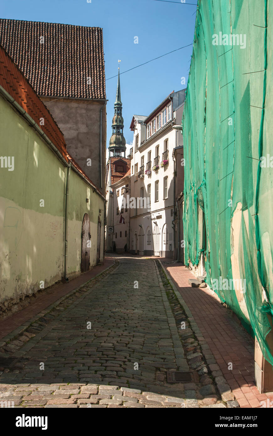 A tiny street in the old town of Riga, largest city and capital of ...