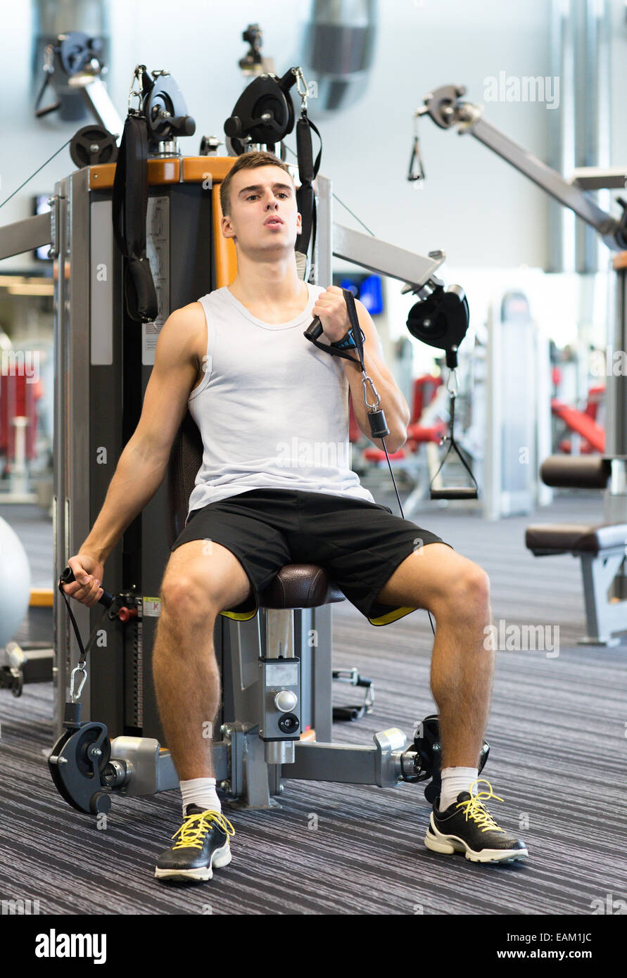 man exercising on gym machine Stock Photo - Alamy