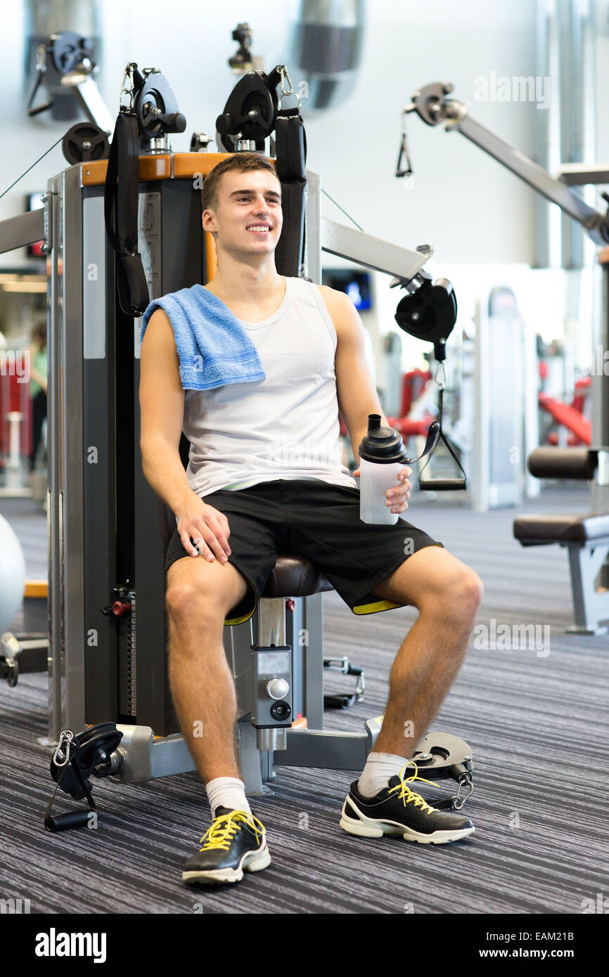 smiling man exercising on gym machine Stock Photo - Alamy