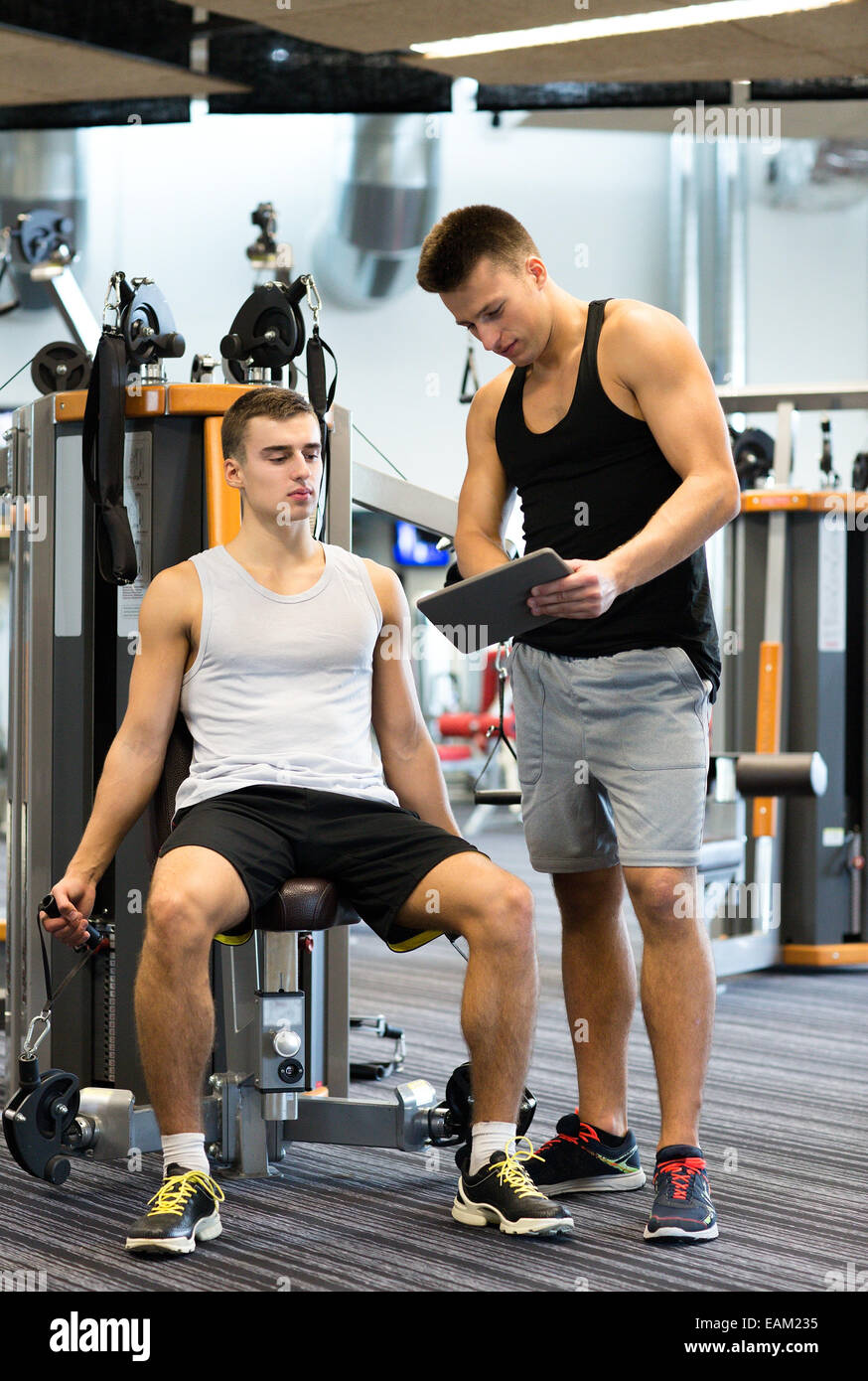 man exercising on gym machine Stock Photo - Alamy