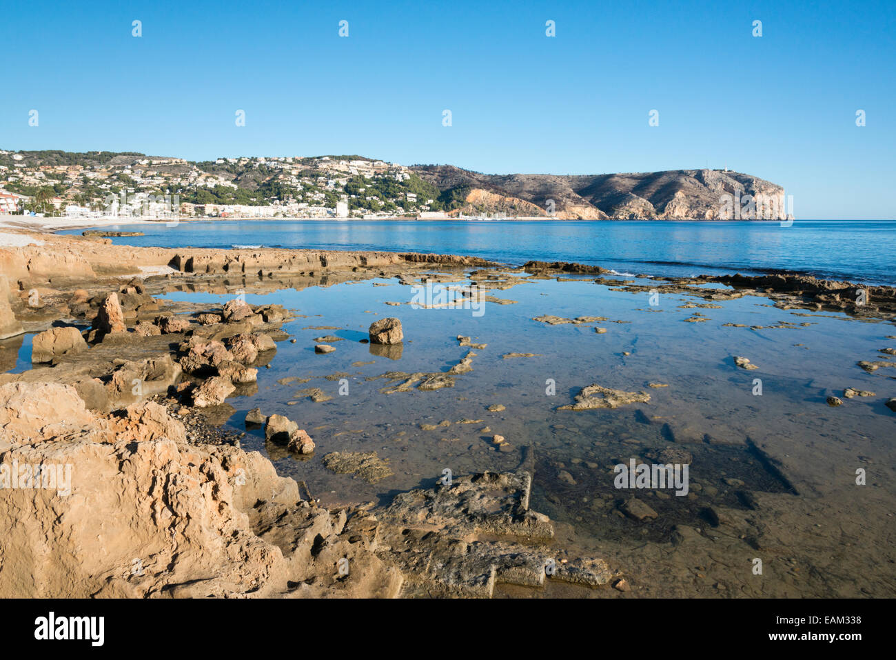 Rockpools and the beach at Javea Costa Blanca Spain looking towards the ...