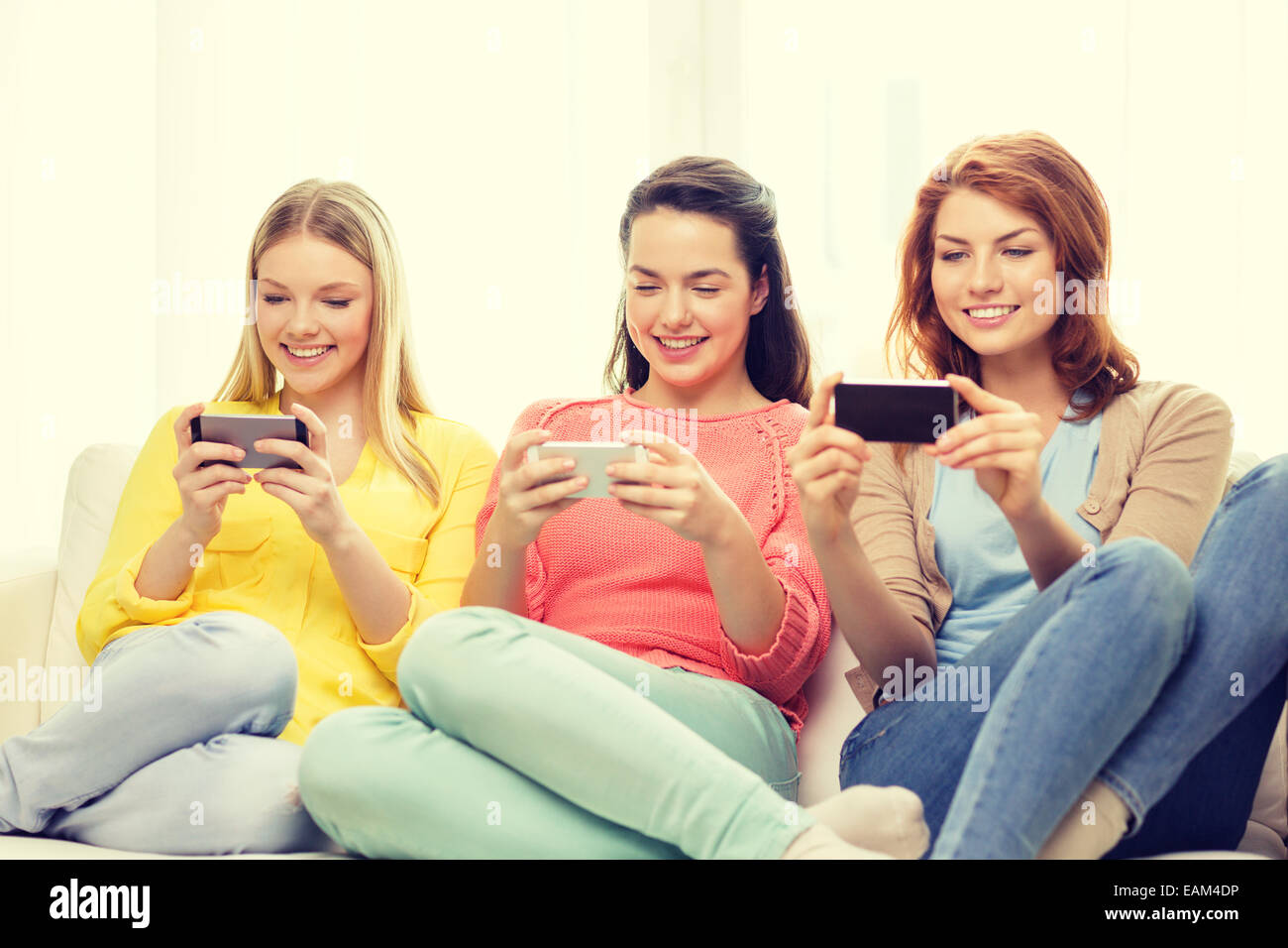 smiling teenage girls with smartphones at home Stock Photo - Alamy