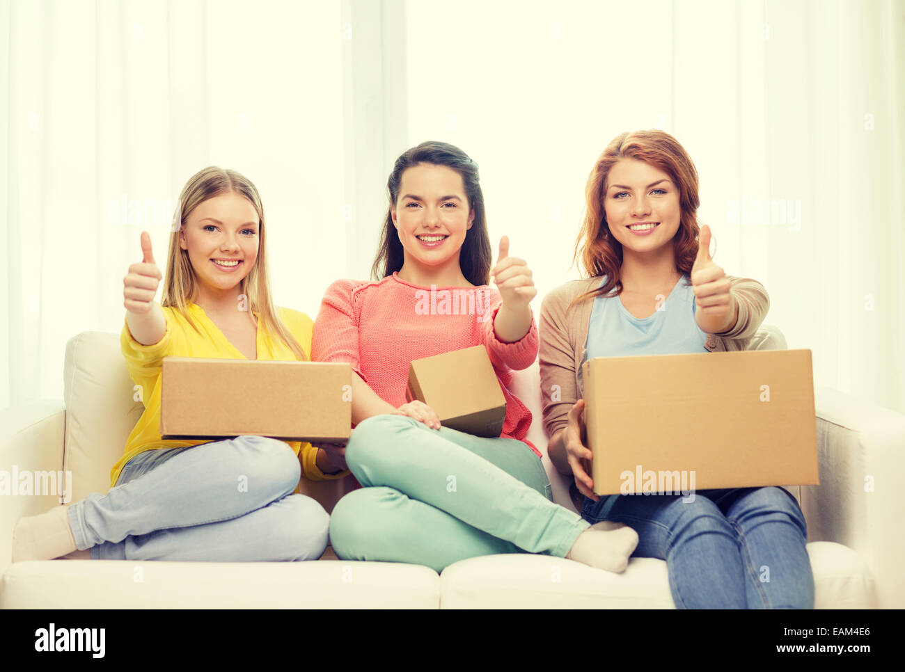 smiling teenage girls with cardboard boxes at home Stock Photo - Alamy