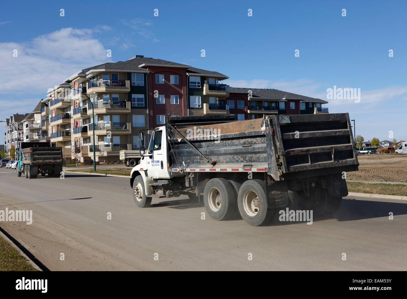 construction dump trucks at new condominium building in suburban ...