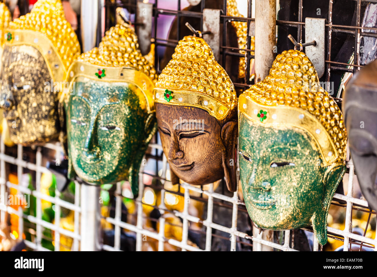 traditional thai buddha wooden masks on sale in a market stall Stock ...