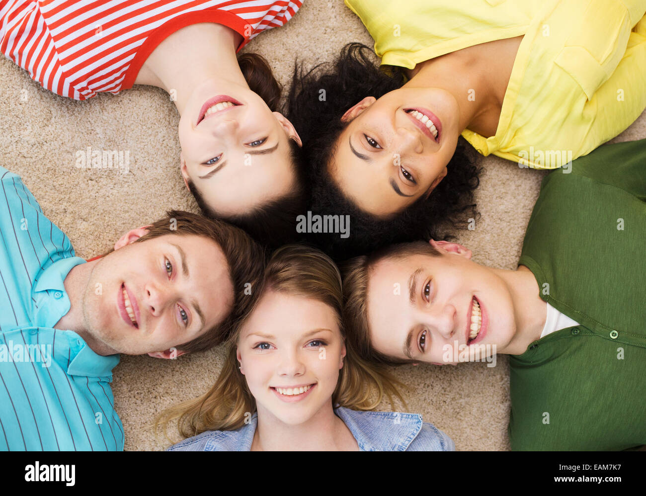 group of smiling people lying down on floor Stock Photo - Alamy