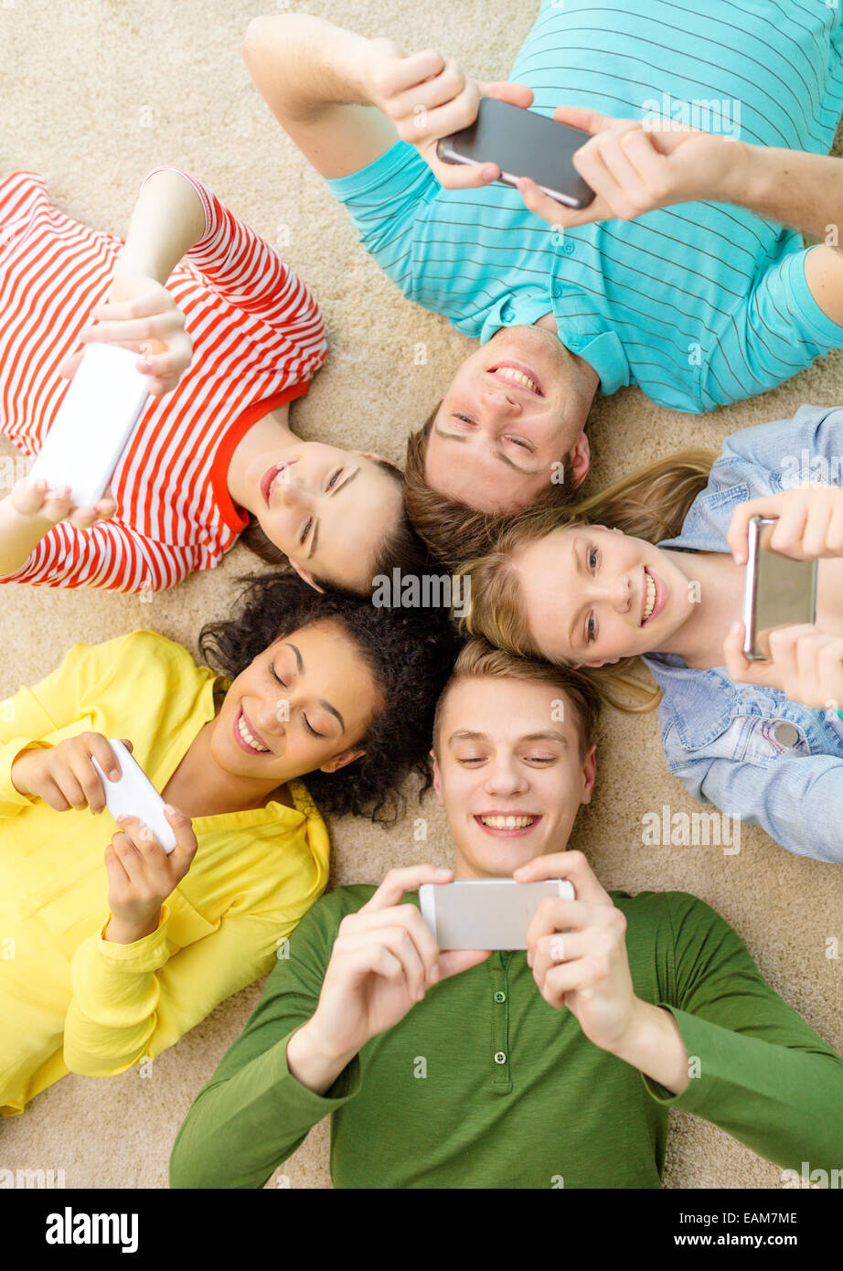 group of smiling people lying down on floor Stock Photo - Alamy