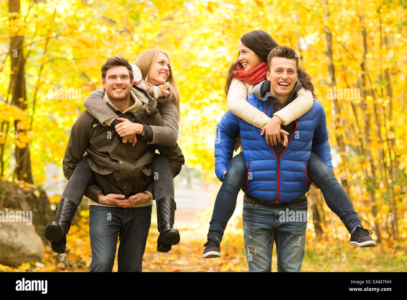 smiling friends having fun in autumn park Stock Photo - Alamy