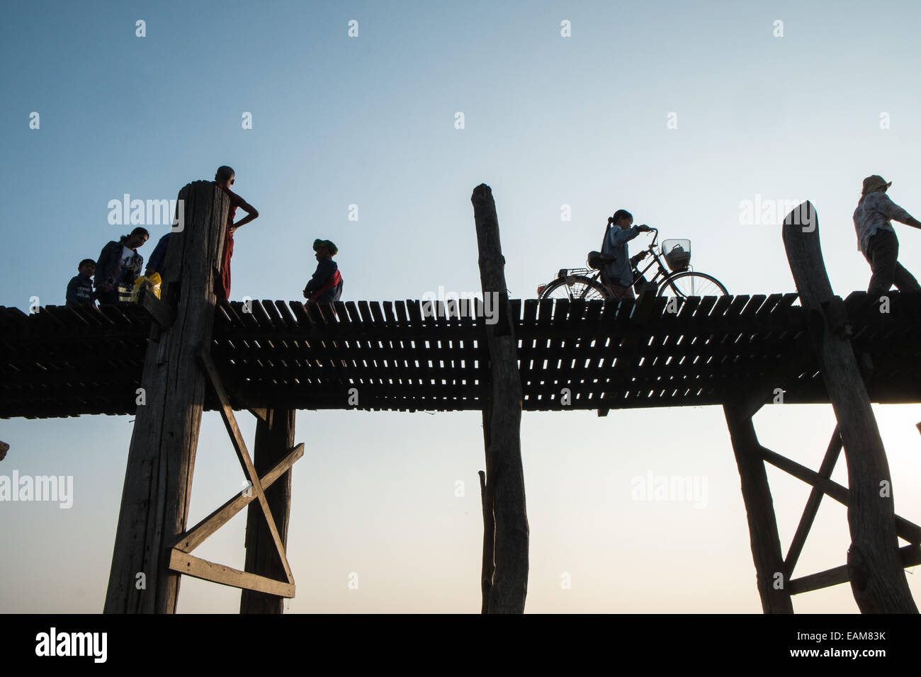 Sunset. Crossing U Bein teak bridge over Taungthaman Lake, near ...