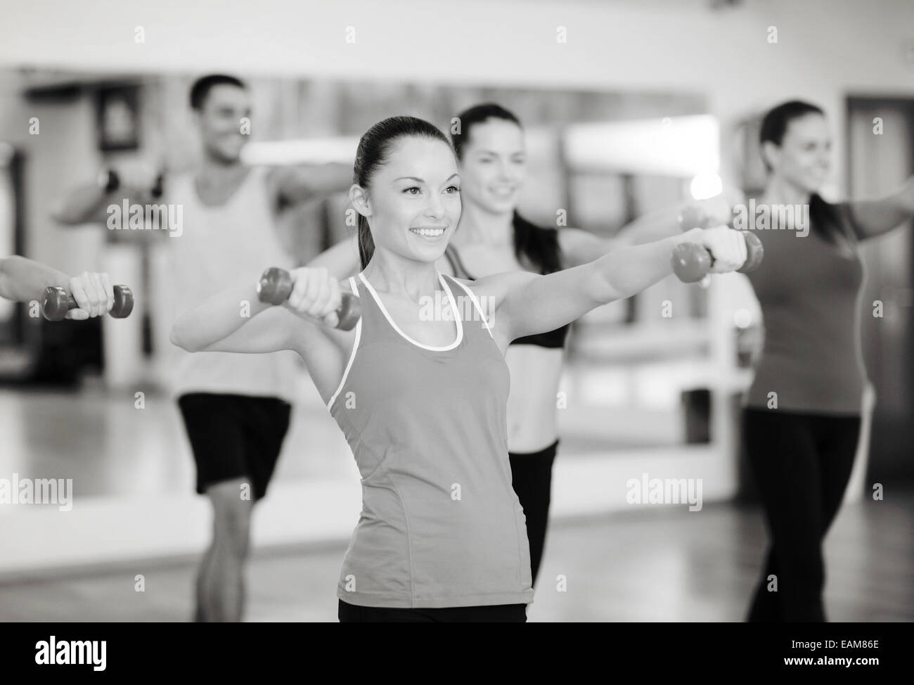group of smiling people working out with dumbbells Stock Photo - Alamy