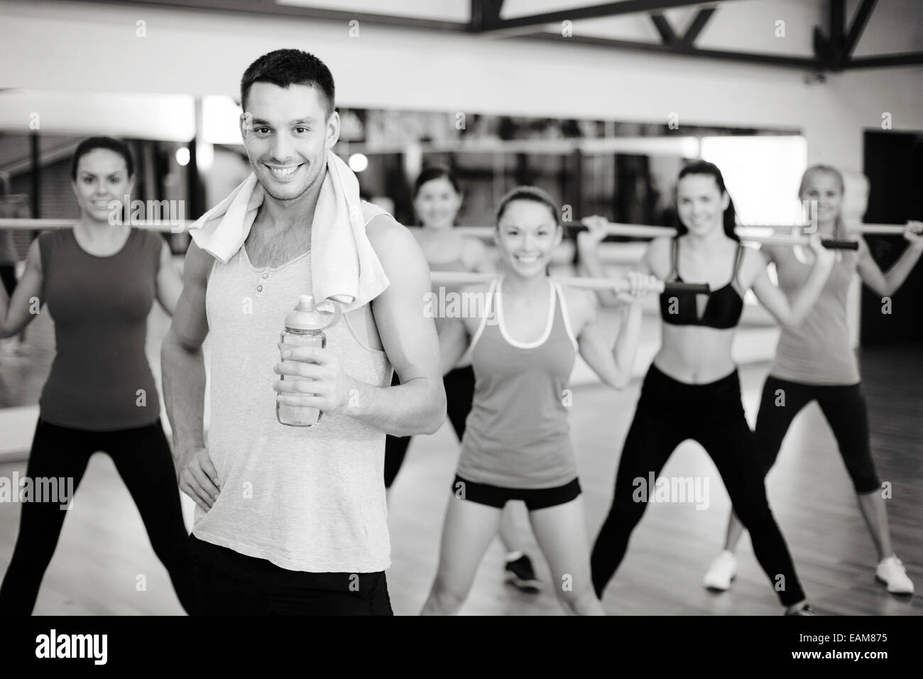 smiling trainer in front of group of people Stock Photo - Alamy