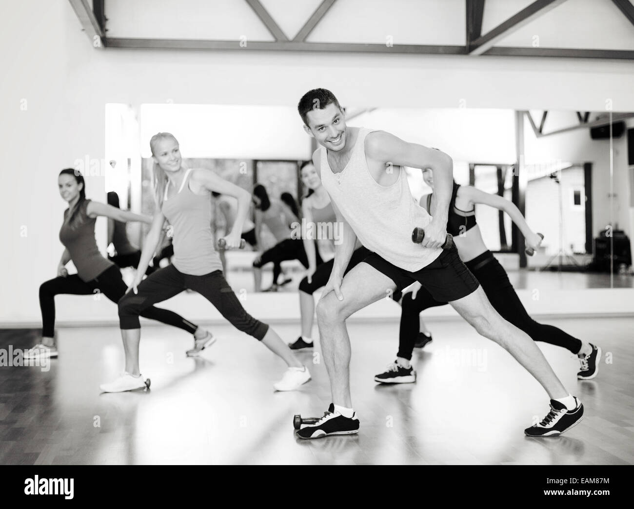 group of smiling people working out with dumbbells Stock Photo - Alamy