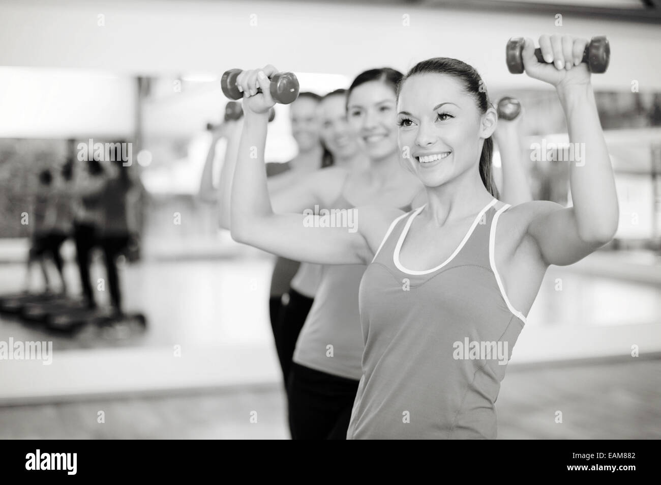 group of smiling people working out with dumbbells Stock Photo - Alamy