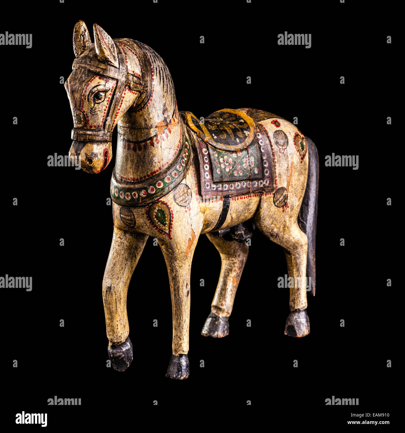 a finely decorated ancient wooden horse isolated over a black ...