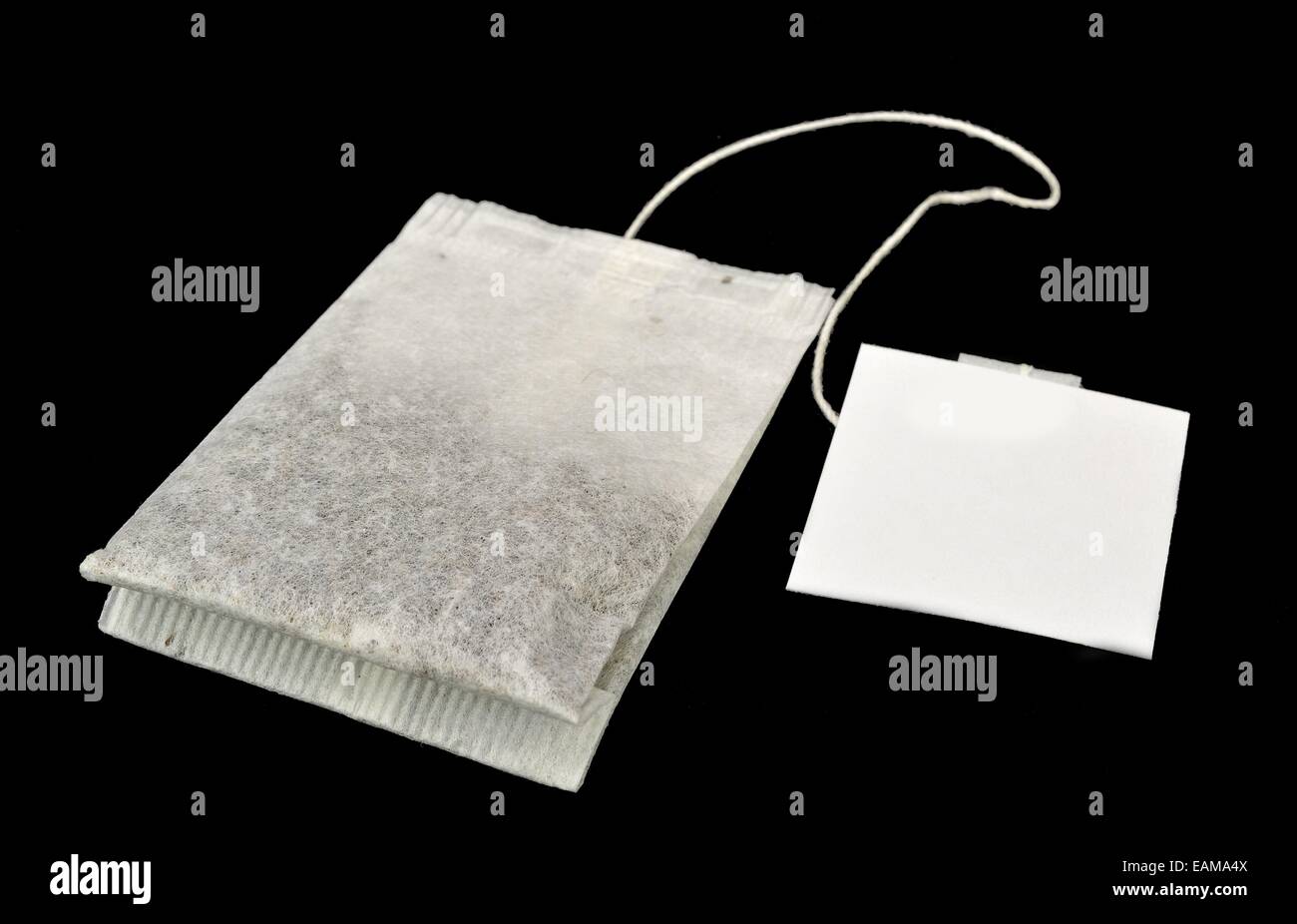 Single tea bag on a black background Stock Photo - Alamy