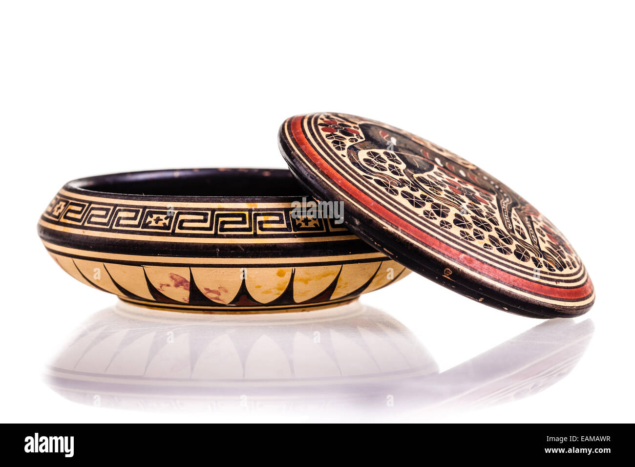 a small round ancient decorated ceramic box isolated over a white ...