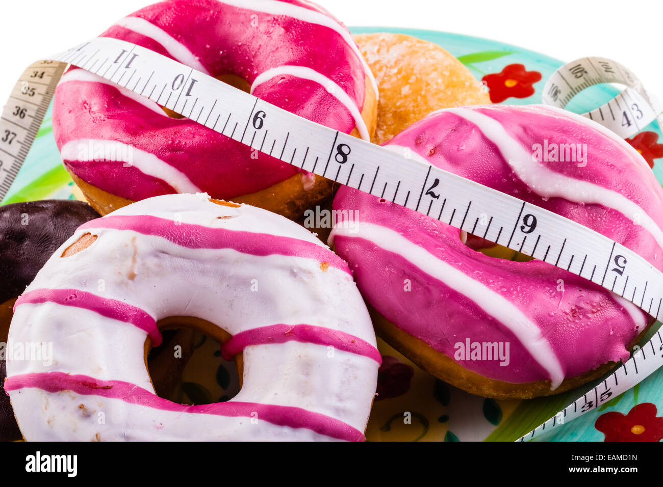 some delicious and colorful donuts with measuring tape Stock Photo - Alamy