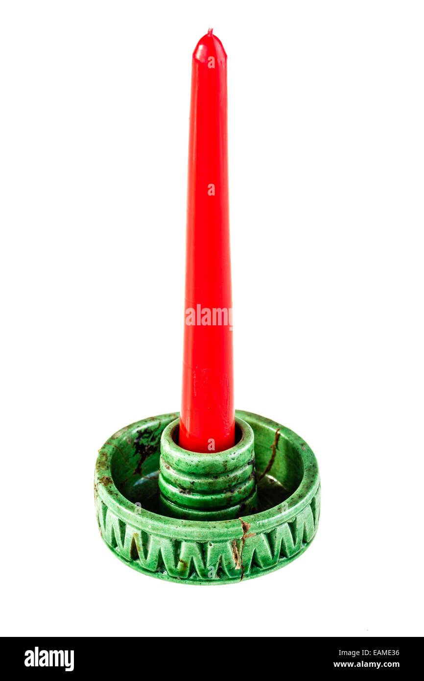 Retro antique candlestick with red candle isolated over a white ...