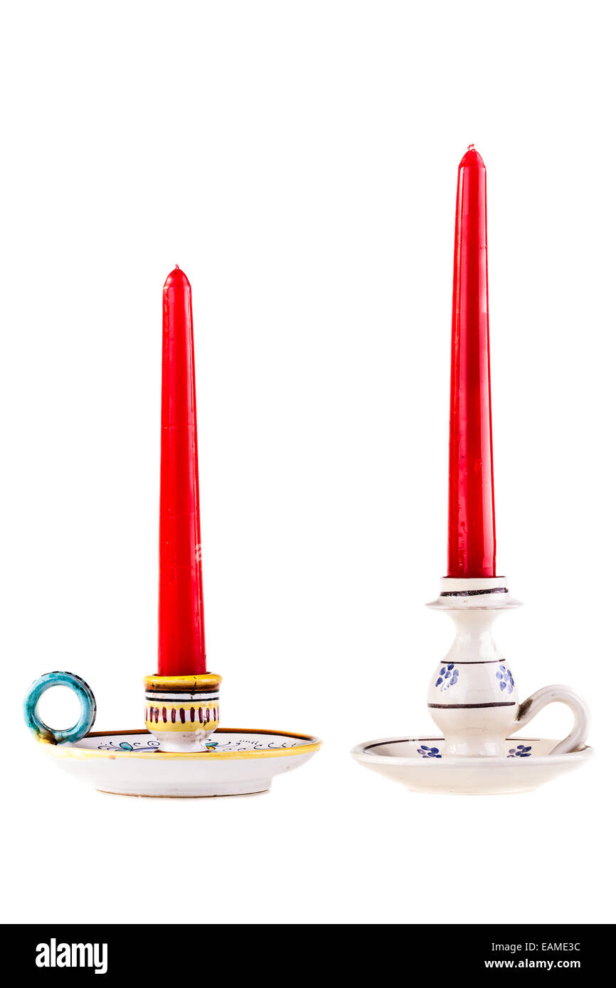 Retro antique candlestick with red candle isolated over a white ...