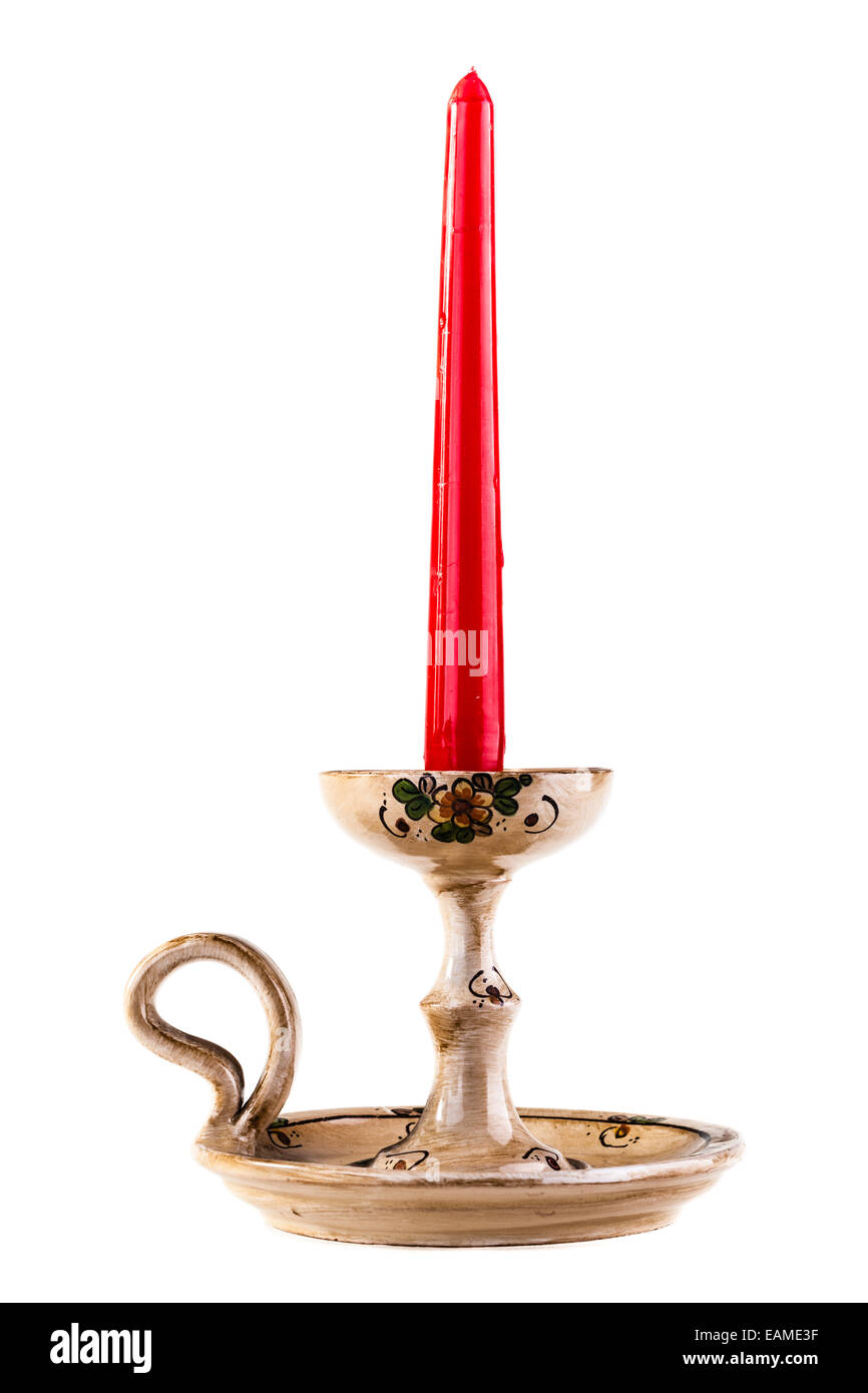 Retro antique candlestick with red candle isolated over a white ...
