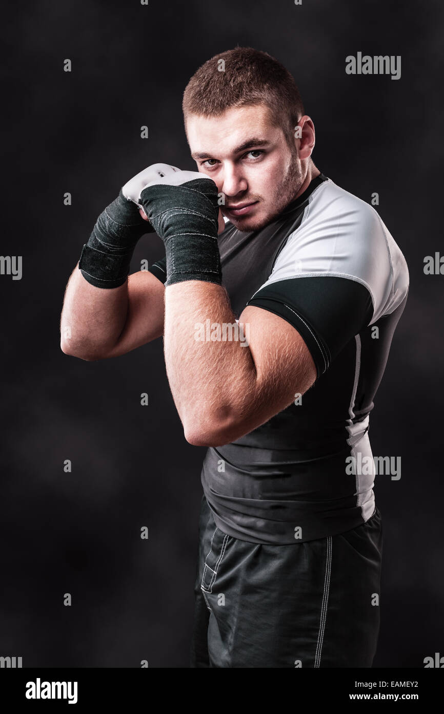 a young kickboxer or boxer posing over a dark background Stock Photo ...