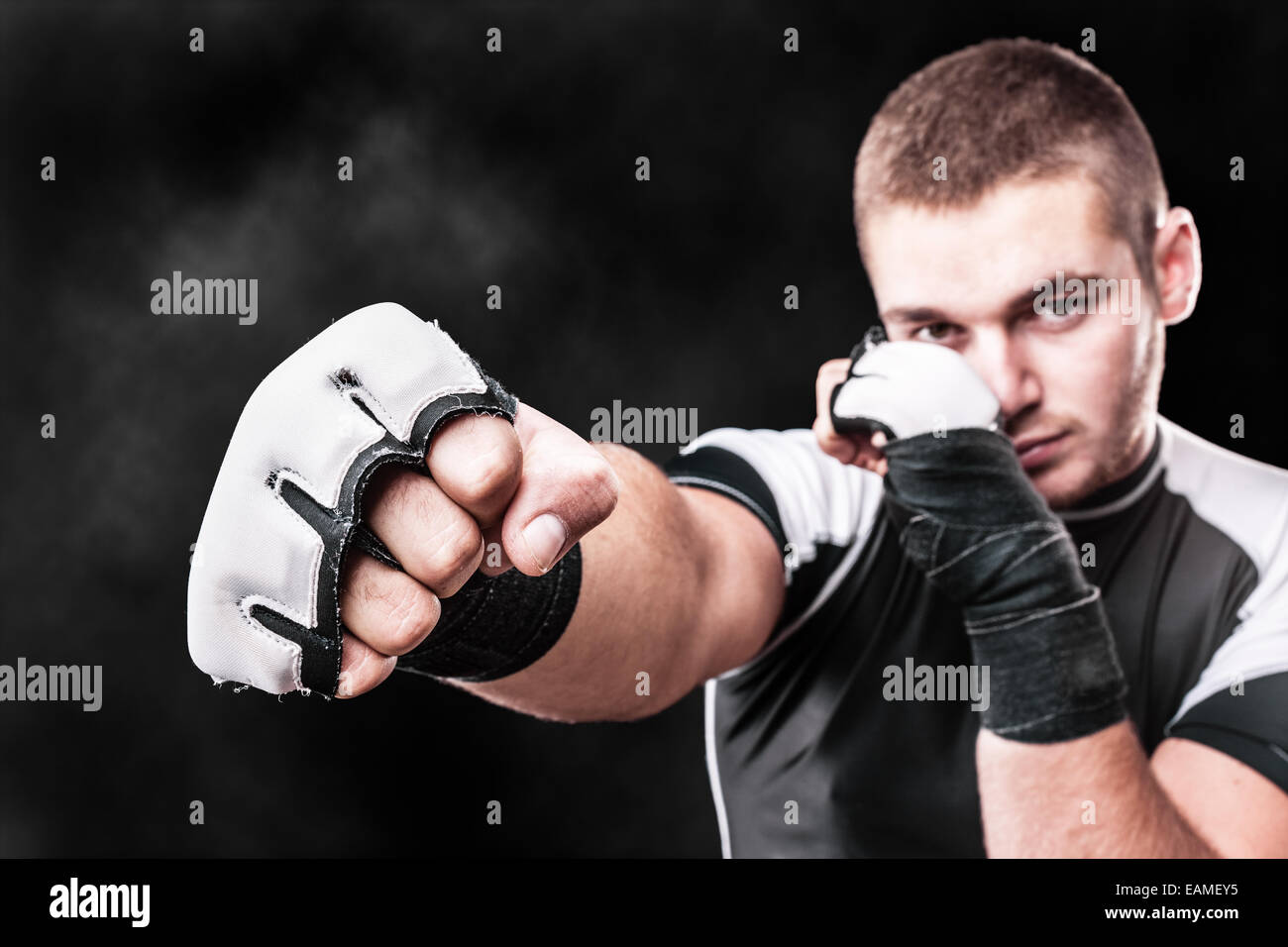 a young kickboxer or boxer posing over a dark background Stock Photo ...