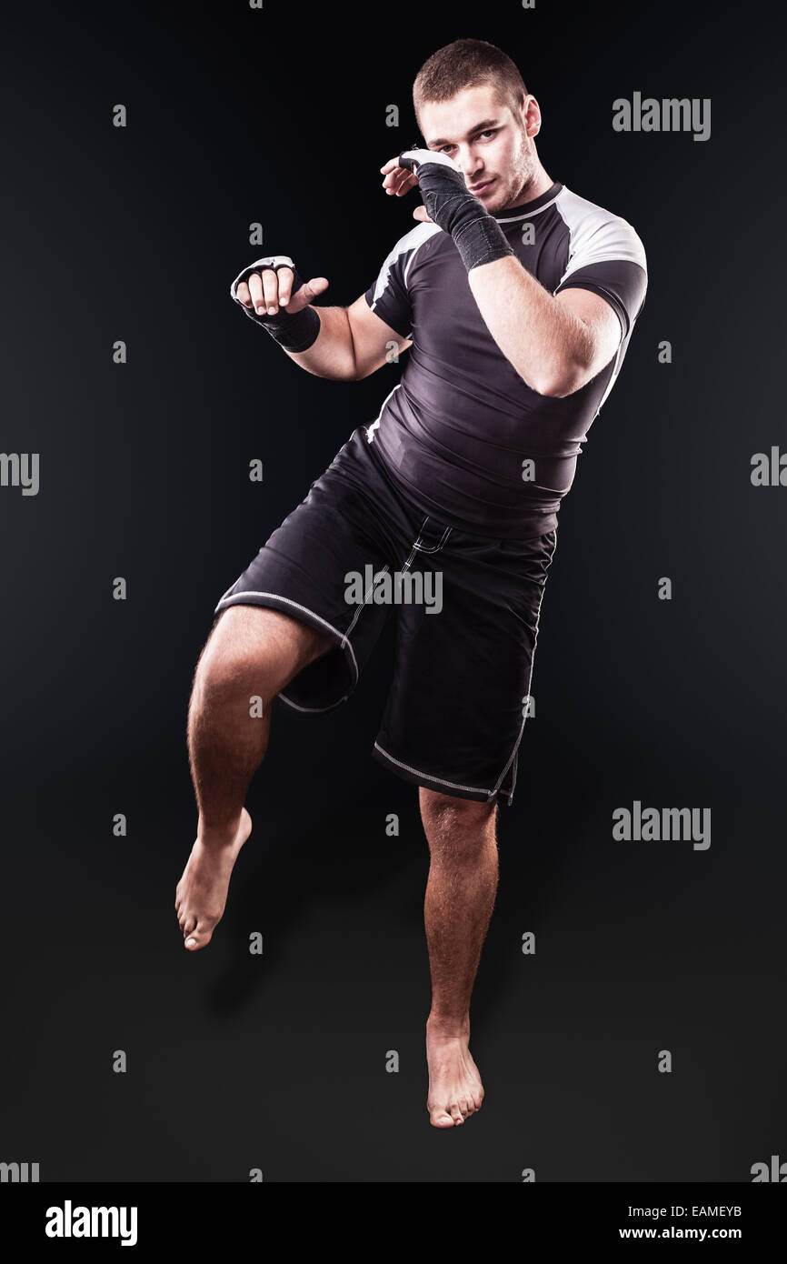 a young kickboxer or boxer posing over a dark background Stock Photo ...