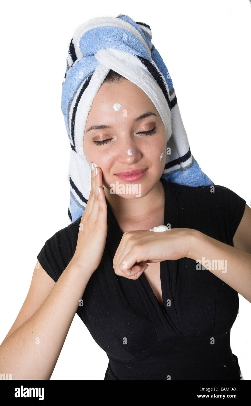 beautiful young woman applying cleaning cream moisturizer to her face ...