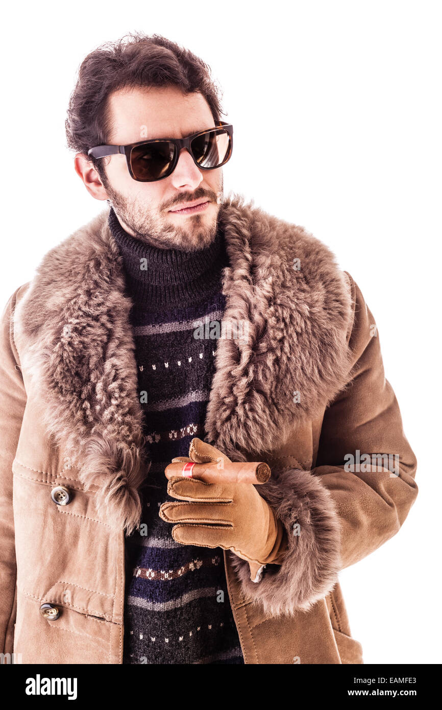 a young and rich man wearing a sheepskin coat isolated over a white ...
