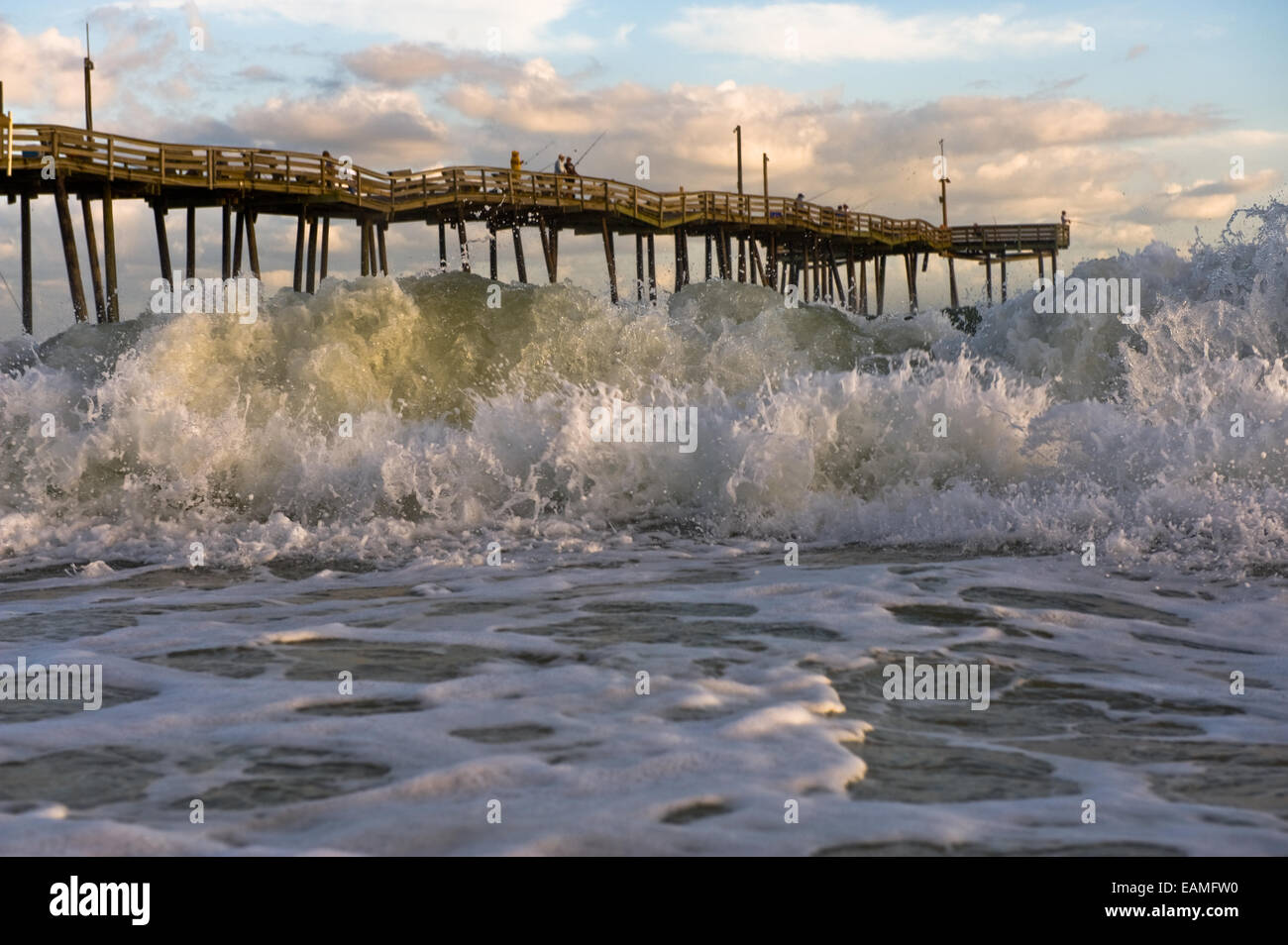 massive wave under pier Stock Photo - Alamy