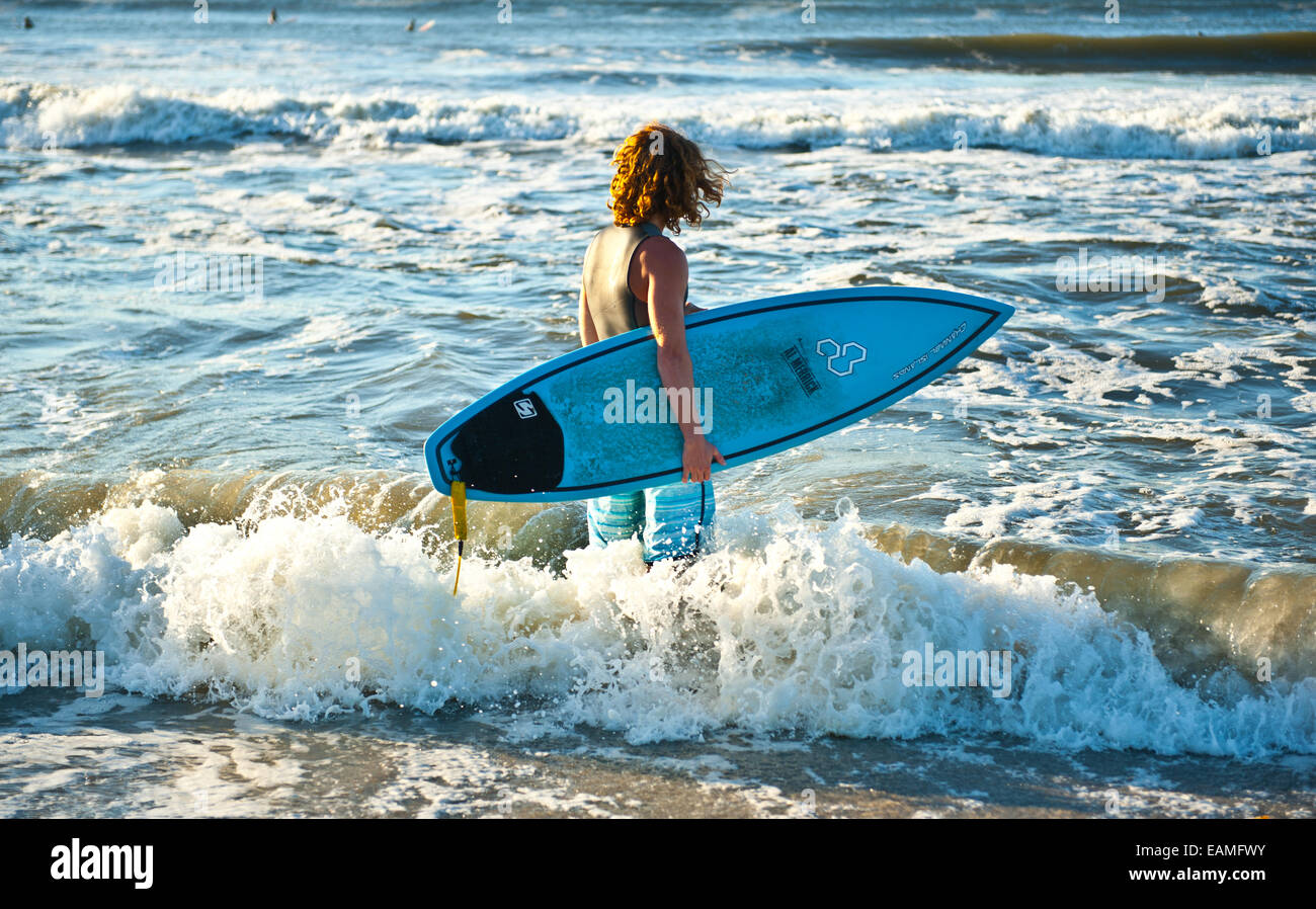 one surfer entering water Stock Photo - Alamy