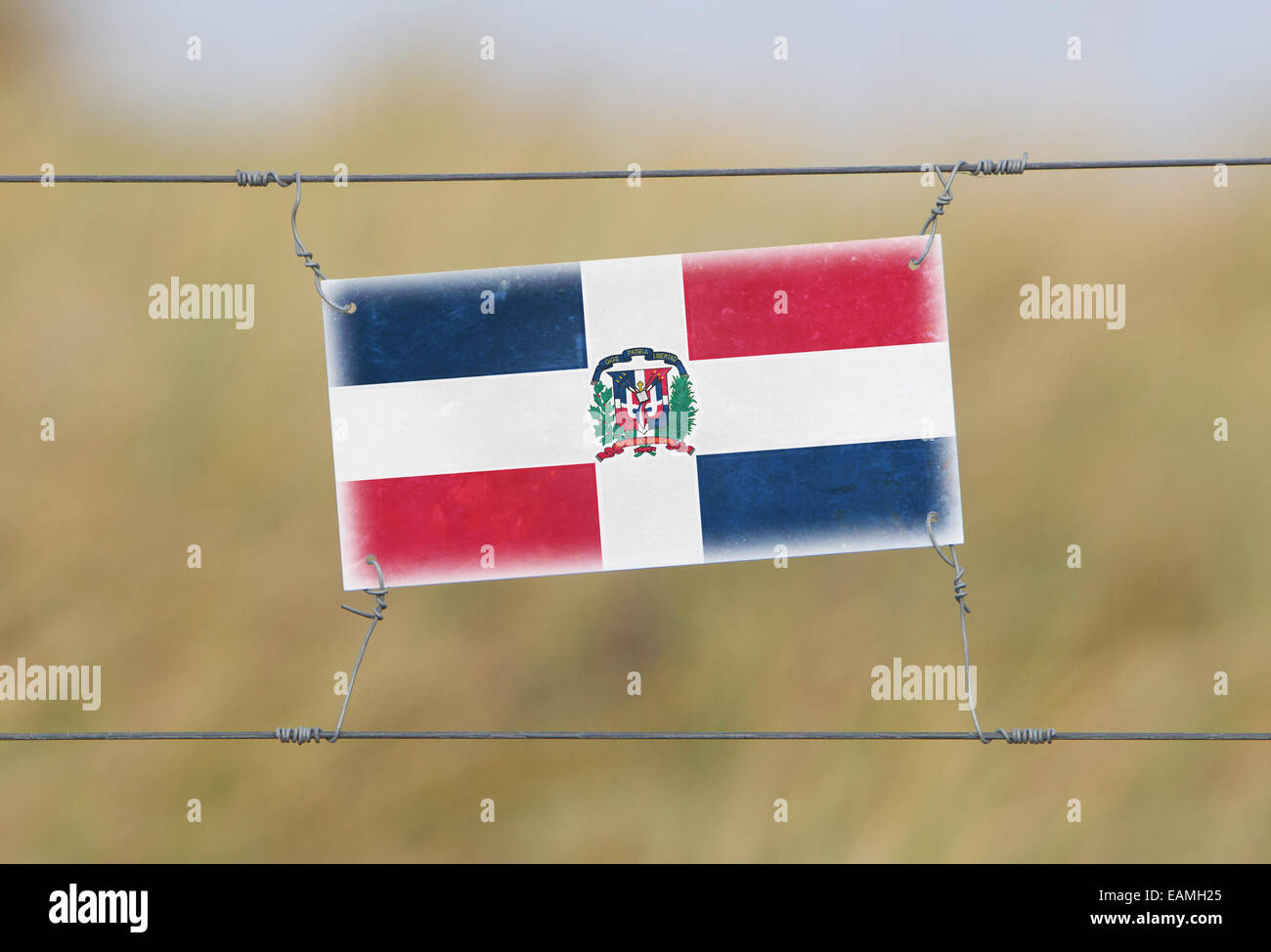 Border fence - Old plastic sign with a flag - Dominican Republic Stock ...