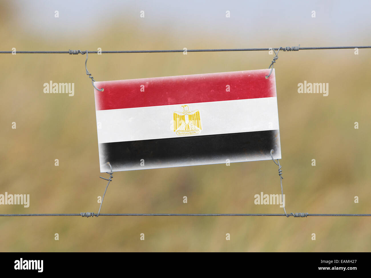 Border fence - Old plastic sign with a flag - Egypt Stock Photo - Alamy