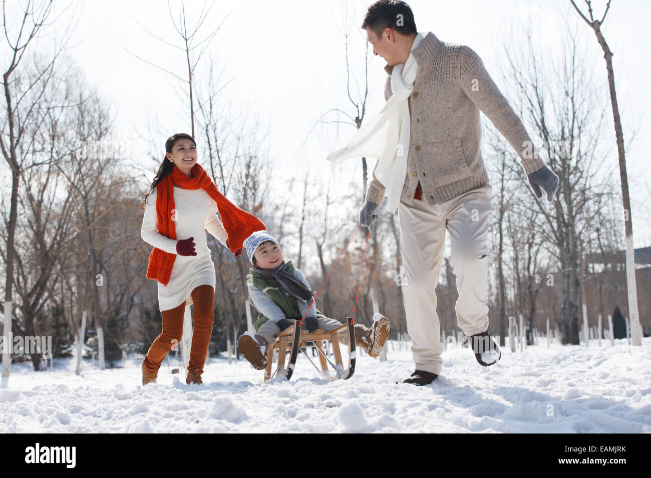 A family of three to play in the snow Stock Photo - Alamy