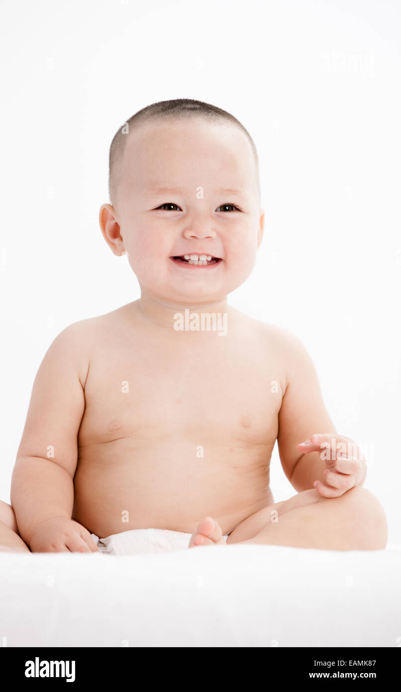 A sat cross-legged on the baby Stock Photo - Alamy