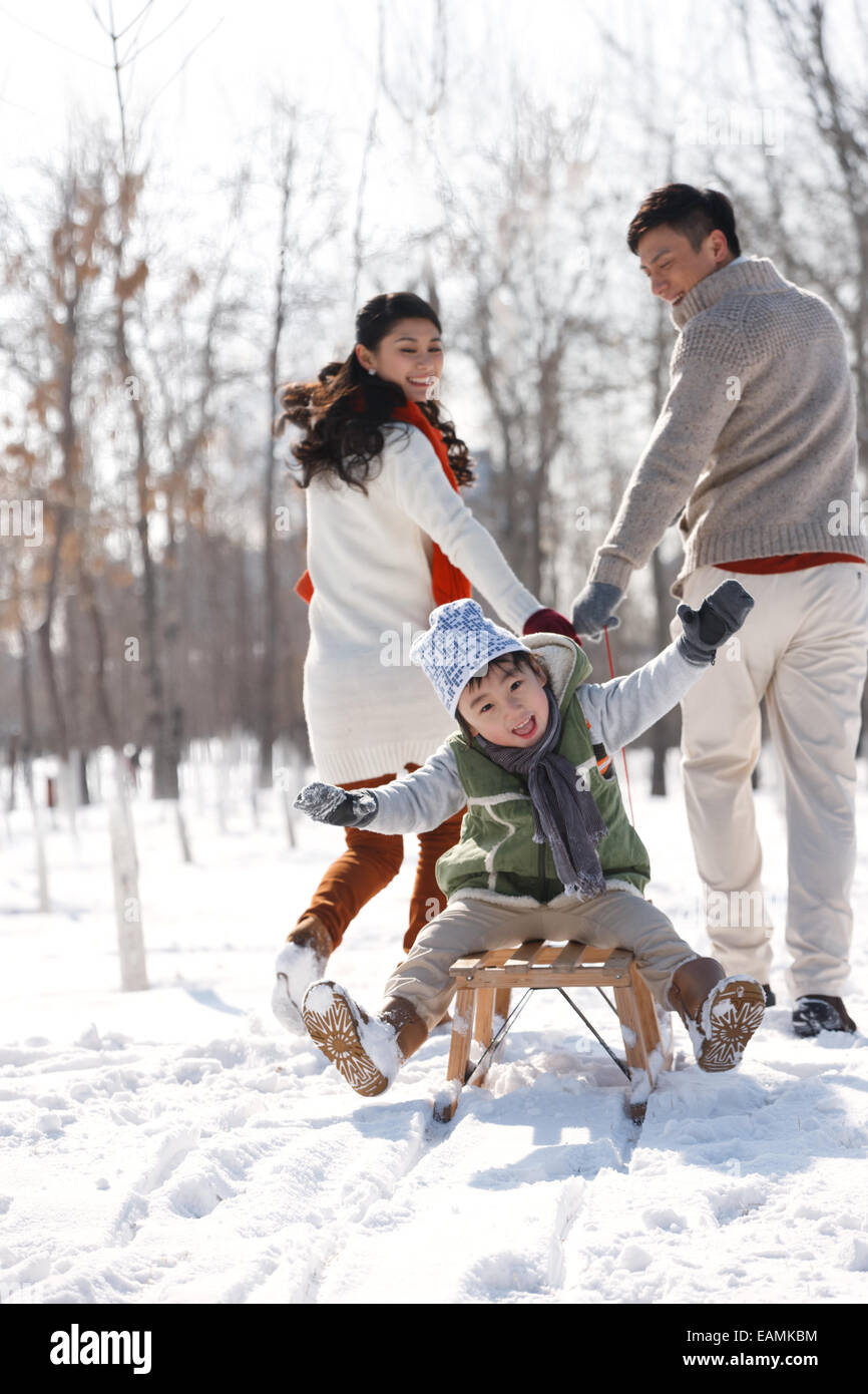Parents with children sitting on a sled Stock Photo - Alamy