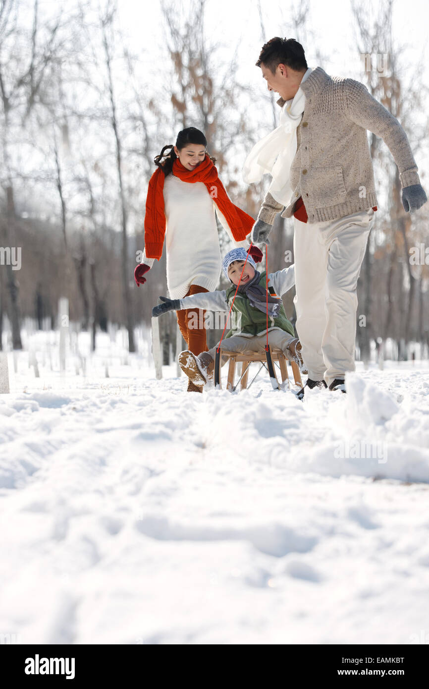 A family of three to play in the snow Stock Photo - Alamy