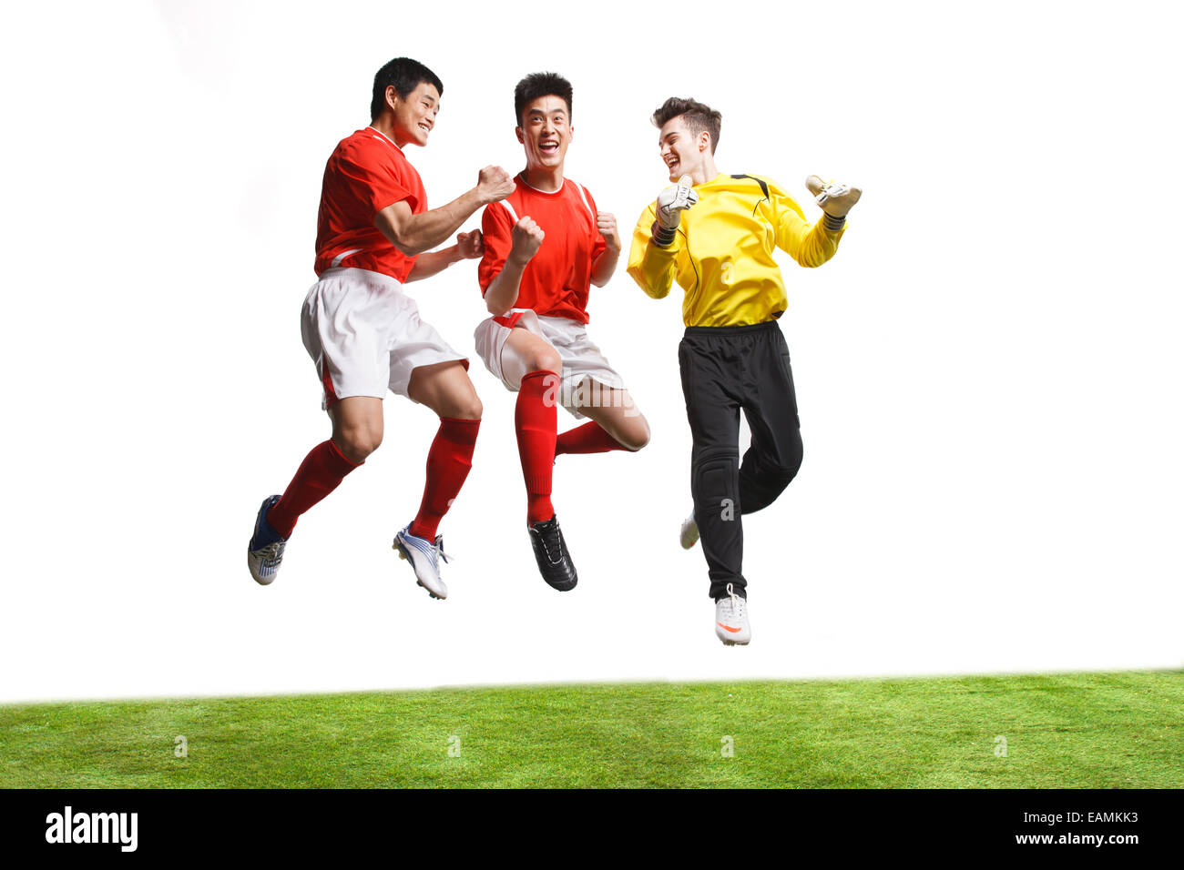 Three football players celebrate your success Stock Photo - Alamy