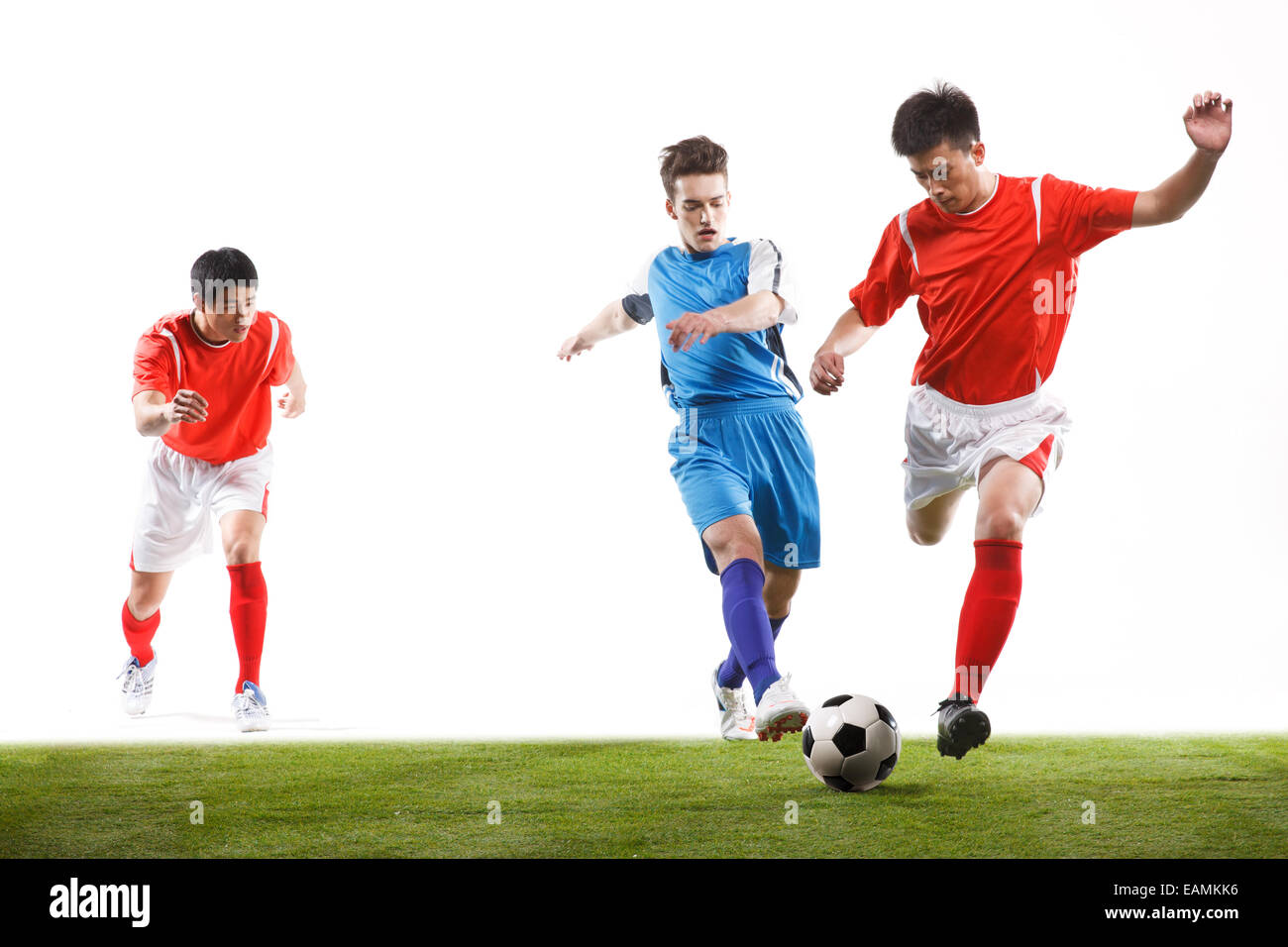 Three football players in football Stock Photo - Alamy