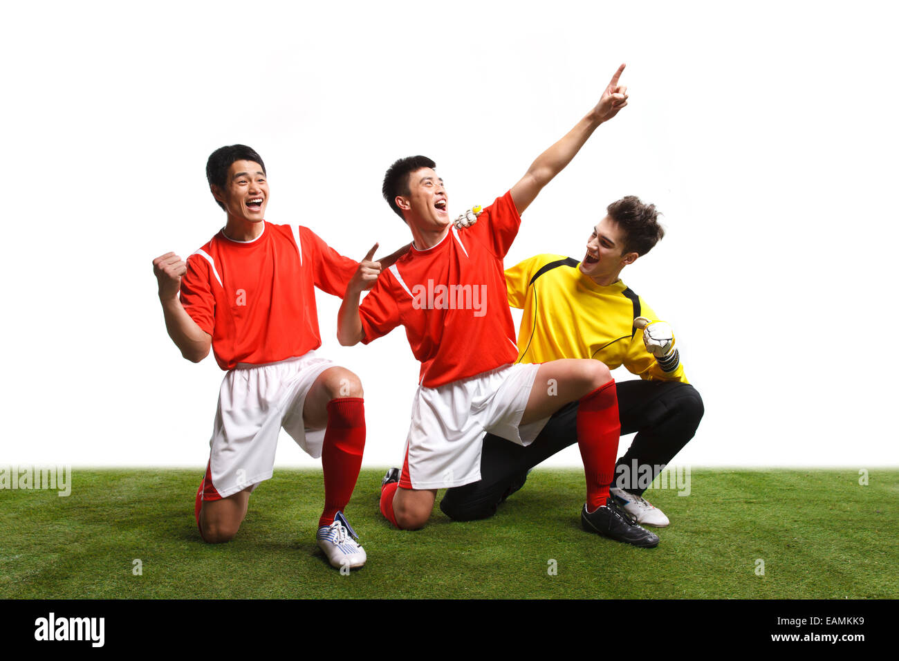 Three football players celebrate your success Stock Photo - Alamy