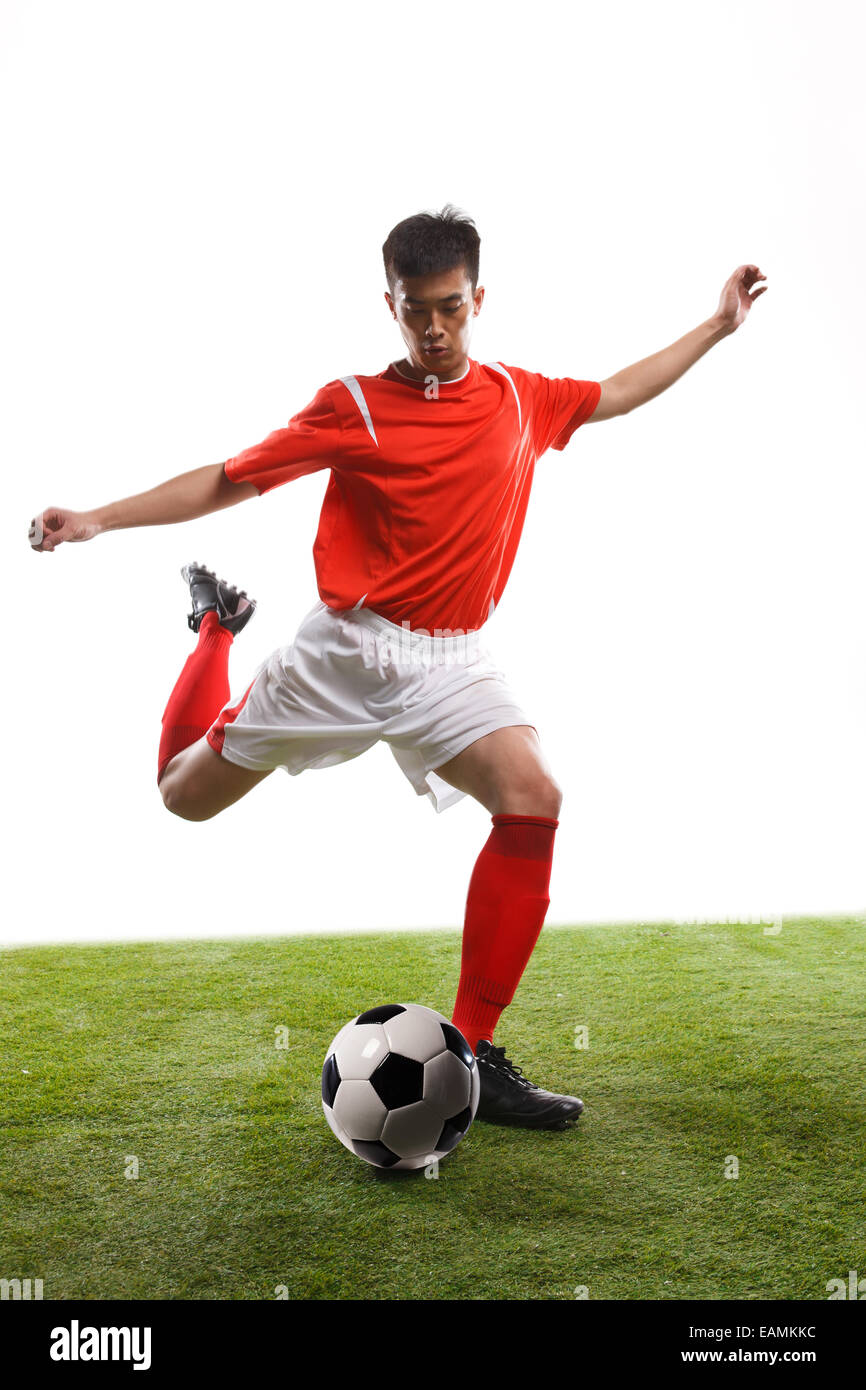 A football player is playing football Stock Photo - Alamy
