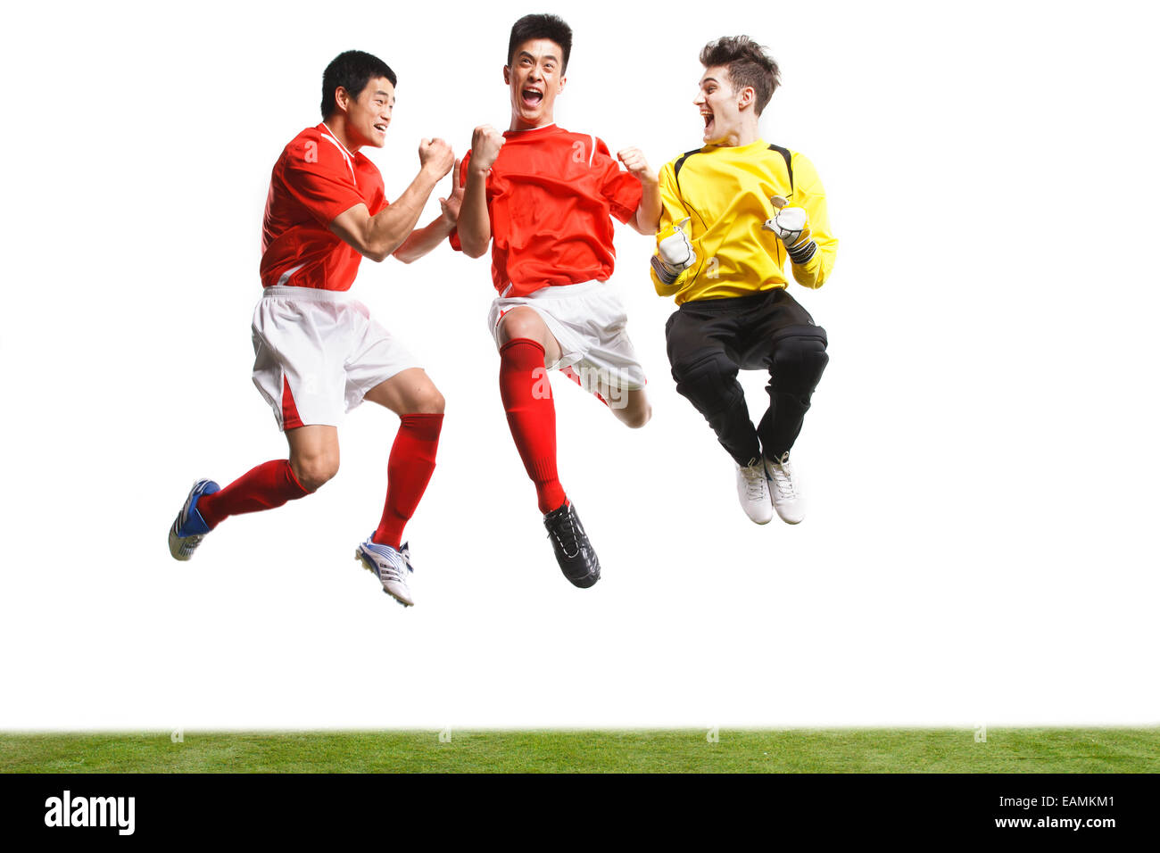 Three football players celebrate your success Stock Photo - Alamy