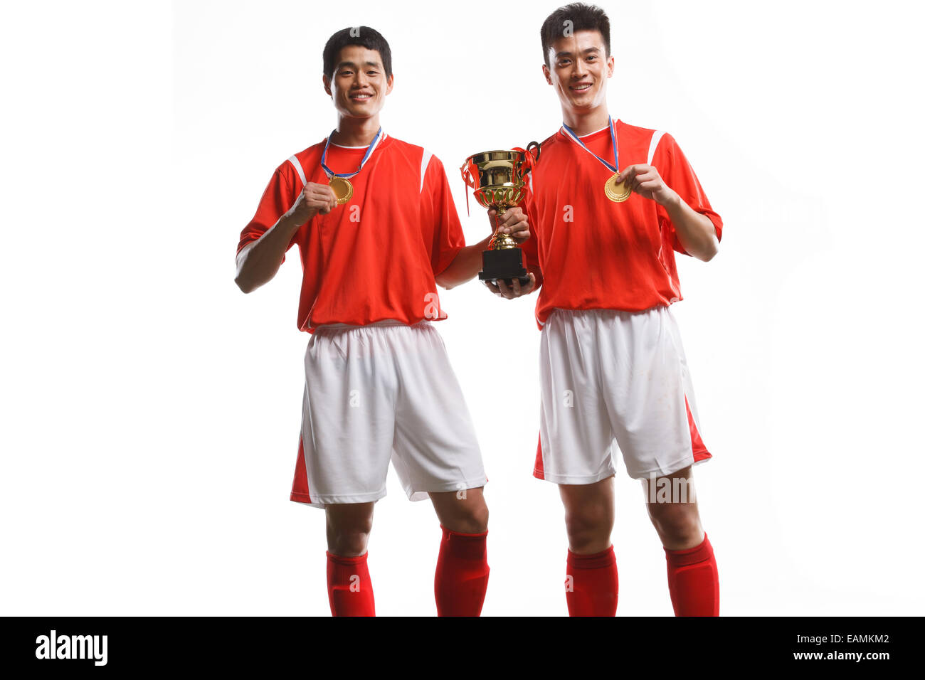 Football players celebrate success with a gold medal Stock Photo - Alamy