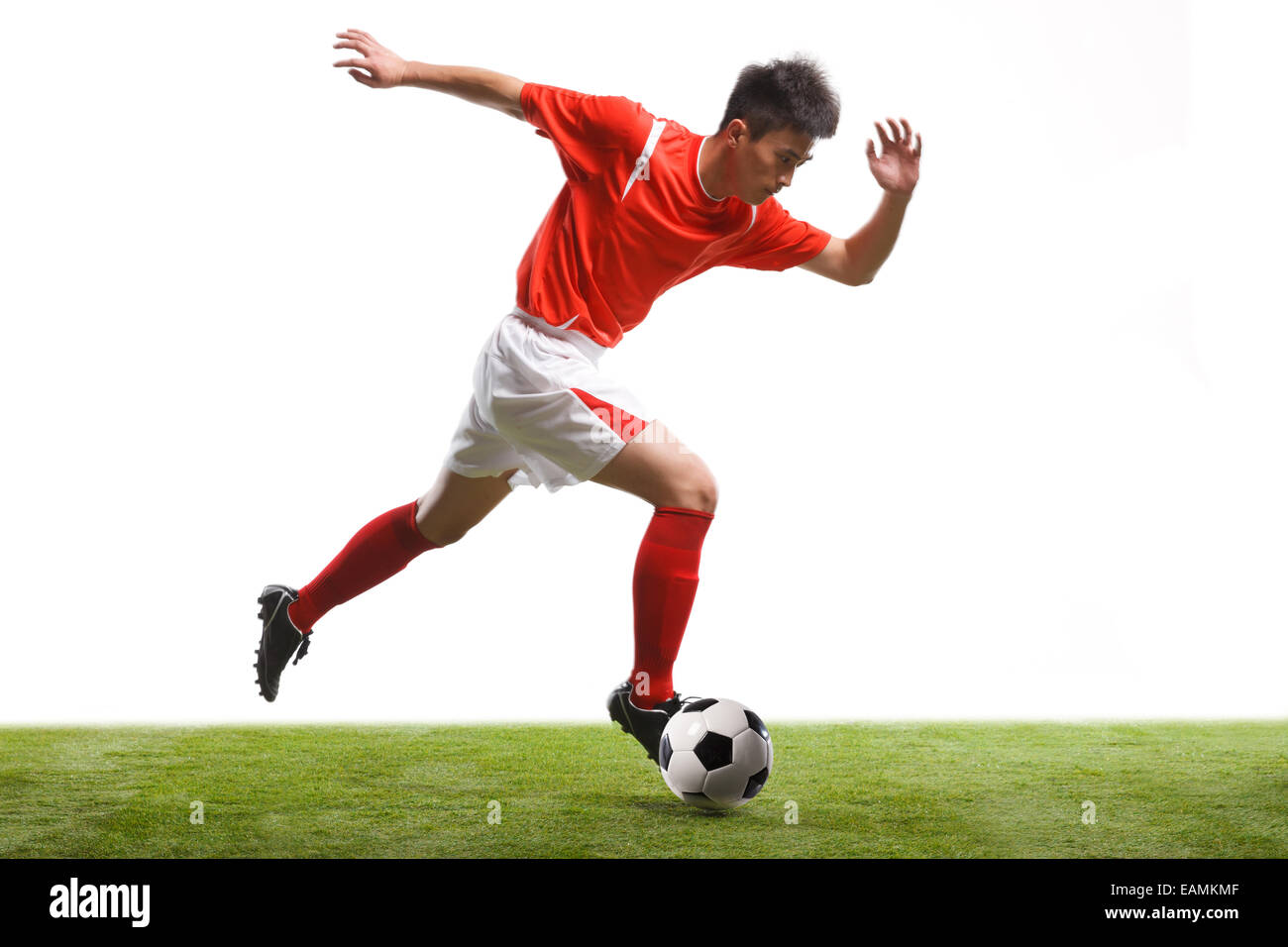 A football player is playing football Stock Photo - Alamy